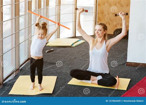 Mamman Och Dottern Utför Tillsammans Olika övningar Fotografering för Bildbyråer Bild av