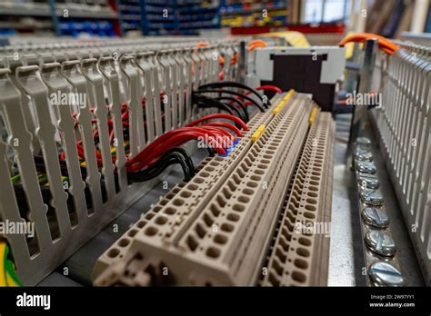 A Factory Assembly Line With An Electronic Cabinet Open Revealing The Intricate Wiring And
