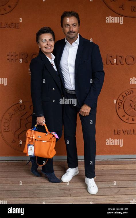 Henri Leconte And Maria Dowlatshahi Take A Pose At Roland Garros For