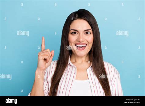 Portrait Of Attractive Cheery Long Haired Girl Pointing Up Copy Blank Space Isolated Over Blue