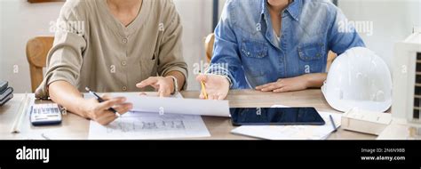 Concept Of Engineering Consulting Two Female Engineers Discussing About Blueprint Of