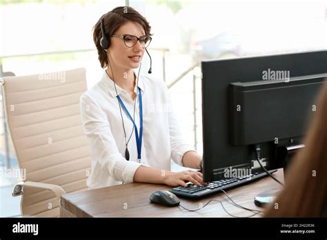 Female Technical Support Operator With Headset At Workplace Stock Photo Alamy