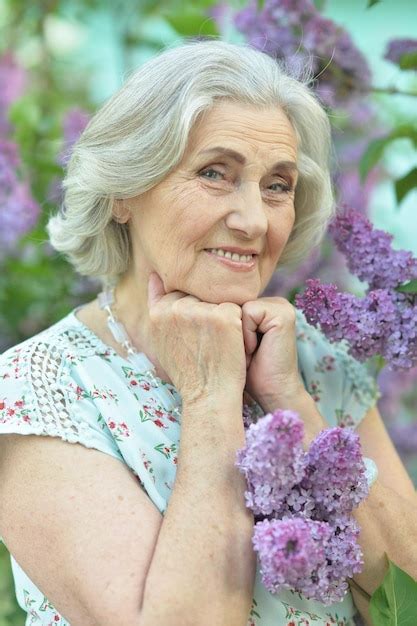 Premium Photo Portrait Of Happy Senior Beautiful Woman On Lilacs