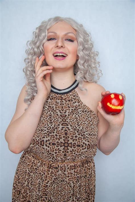 Chubby Blonde Girl Wearing Summer Dress And Posing With Big Red Apple On White Background Alone