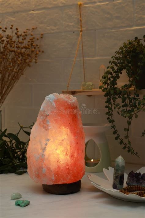 Himalayan Salt Lamp Crystals And Oil Diffuser On White Table Near
