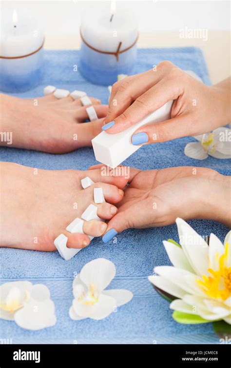 Cropped Image Of Pedicurist Filing Toenails Of Woman In Beauty Salon Stock Photo Alamy