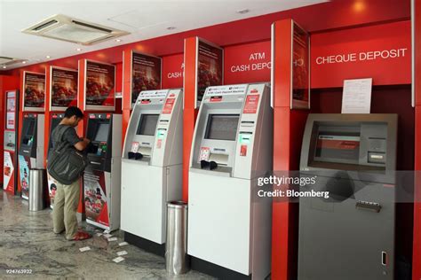 A Customer Uses An Automated Teller Machine At A Cimb Bank Bhd News