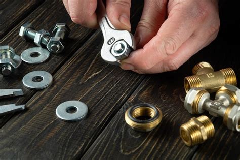 Premium Photo Tightening A Nut With A Wrench In The Hands Of A Master