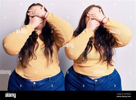 Young Plus Size Twins Wearing Casual Clothes Covering Eyes And Mouth