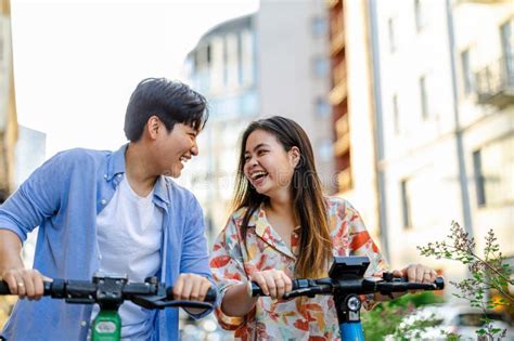 Young Couple Using Electric Scooters In The City Stock Image Image Of Emissions Activities