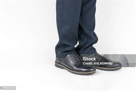 Businessmans Legs In Formal Trousers And Black Leather Shoes On White