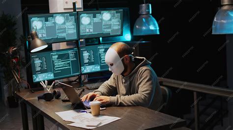 Premium Photo Cyber Impostor Wearing Mask Hacking Database Servers