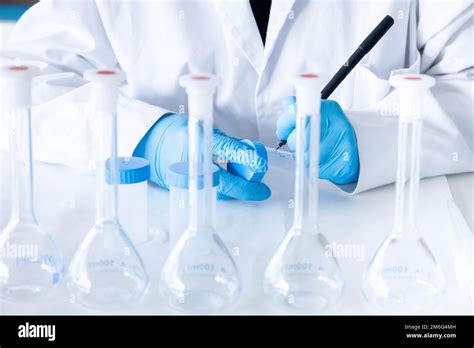 Close Up Left Handed Woman Scientist Labeling Samples With Blue Gloves