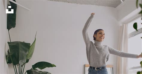 흰색 긴 소매 셔츠와 파란색 데님 청바지를 입은 사람이 흰색 침대에 서 있다 사진 Unsplash의 무료 사람 이미지