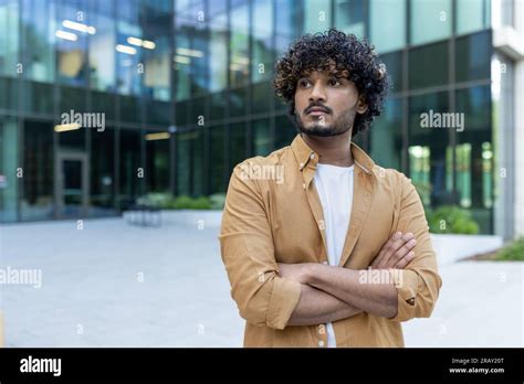 Portrait Of A Young Indian Male Programmer Developer Standing With Crossed Arms Outside The