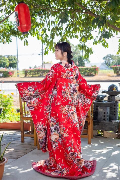 The Girl Is Wearing A Red Traditional Kimono Which Is The National
