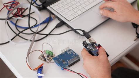 Male Programmer Creates Robotics An Arduino Board Controls Servo Motors DIY Mechanics