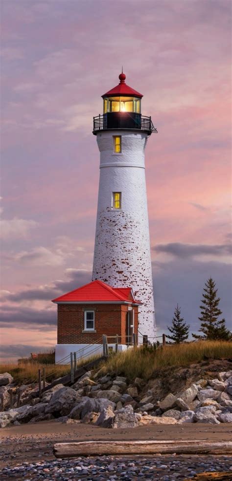 Hot Air Balloons Flying Over A Lighthouse At Sunset Light Houses