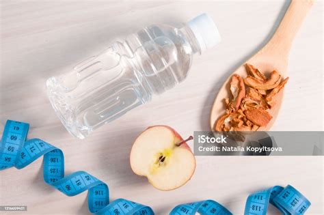사과 반 물 한 병 마른 사과와 나무 테이블에 파란색 측정 테이프와 큰 나무 숟가락 적절한 영양 개념 물 균형을 유지 0명에 대한 스톡 사진 및 기타 이미지 Istock