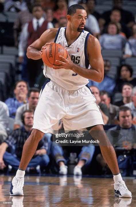 Forward Juwan Howard Of The Dallas Mavericks Holds The Ball During