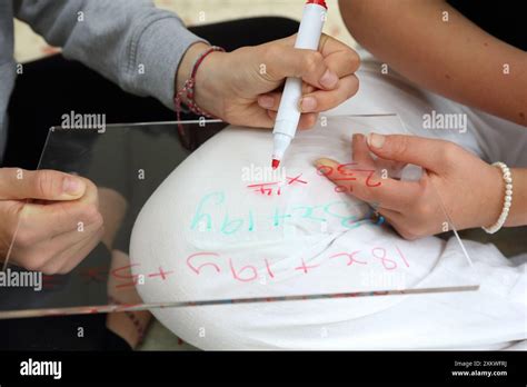 Girls Doing Maths Math Sitting On Floor Writing On Whiteboard With Pens Algebra Fractions