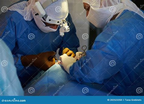 Surgery The Chief Surgeon Uses Scissors To Make An Incision The Assistant Holds The Retractor