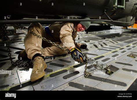 A Us Air Force C 17 Loadmaster Unchains An Ah 64d Apache Longbow To