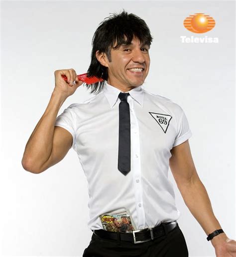 A Man In A White Shirt And Black Tie Holding A Red Object Up To His Ear