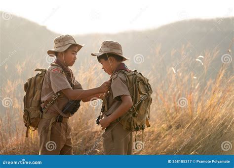 Asian Two Scouts Check Each Other`s Attire Before Making The Long Journey To Scout Camp Stock