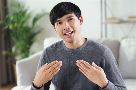 Young Asian Deaf Disabled Man Using Sign Language To Communicate With Other People Stock Image