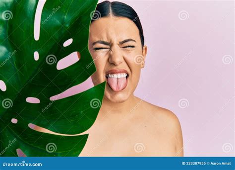 Beautiful Brunette Woman Holding Green Plant Leaf Close To Beautiful