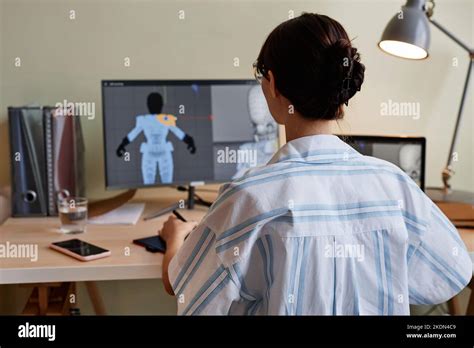 Back View Of Female Designer Building 3d Models And Using Computer At