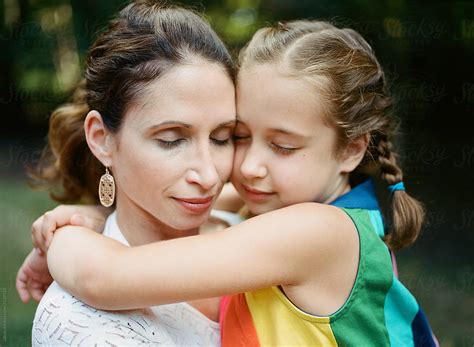Daughter Embracing Mother With Eyes Closed By Stocksy Contributor