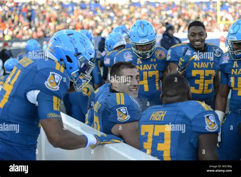 Players From The Us Naval Academy Midshipmen Football Team Encourage