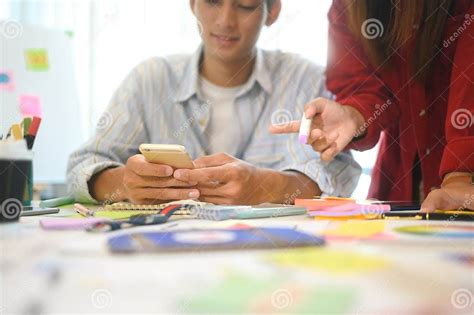 Team Of Creatives Collaborating On A Ux Ui Project At Workspace Filled With Flowcharts And