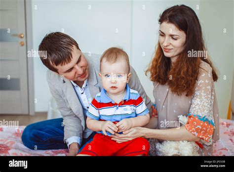 Glückliche Familie Mutter Vater und Tochter auf dem weißen Bett Stockfotografie Alamy