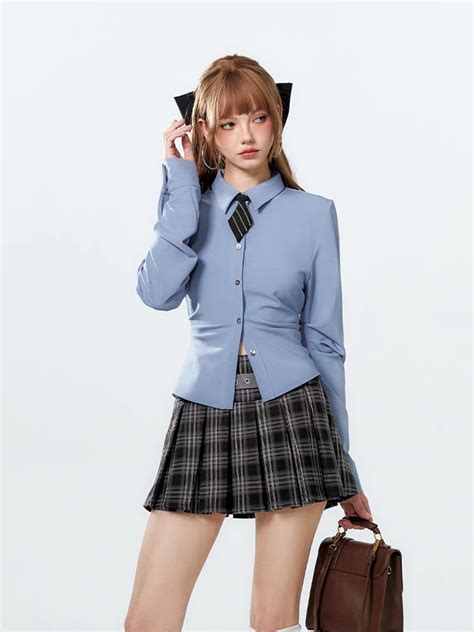 A Mint Green Pleated Shirt With A Diamond Necktie And A Fitted Waist