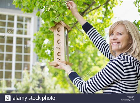 Woman Hanging Bird Feeder Tree Branch Hi Res Stock Photography And Images Alamy
