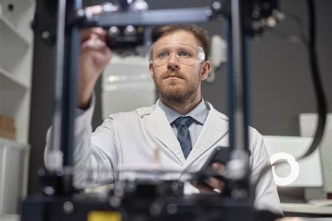 Premium Photo Male D Printer Engineer Setting Up Equipment