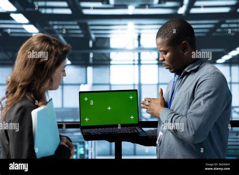 Engineers In Data Center Using Isolated Screen Notebook Observing Analytics Reviewing