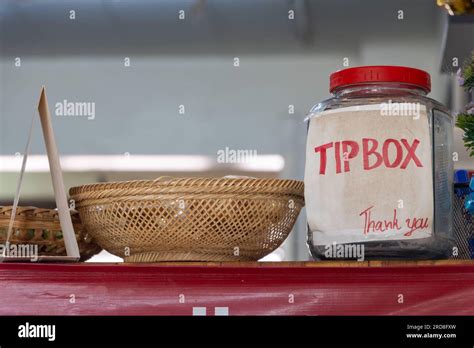 A Bottle With A Tip Box Sign On The Counter In The Restaurant Stock
