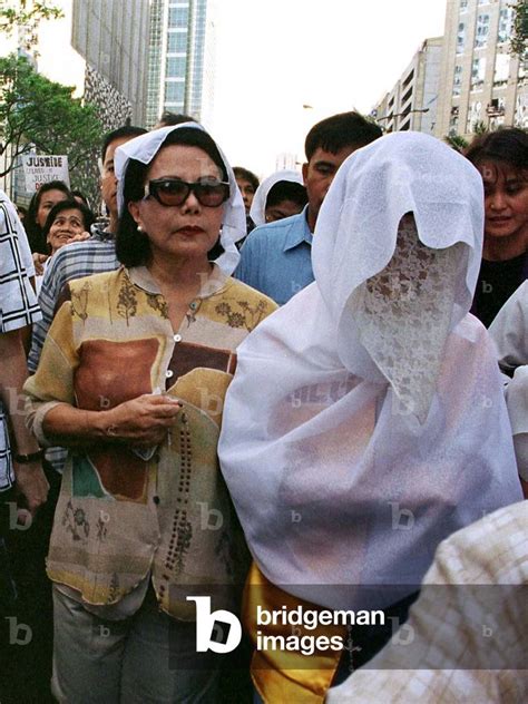 Image Of Philippine First Lady Luisa Ejercito Clutches A Rosary While Marching