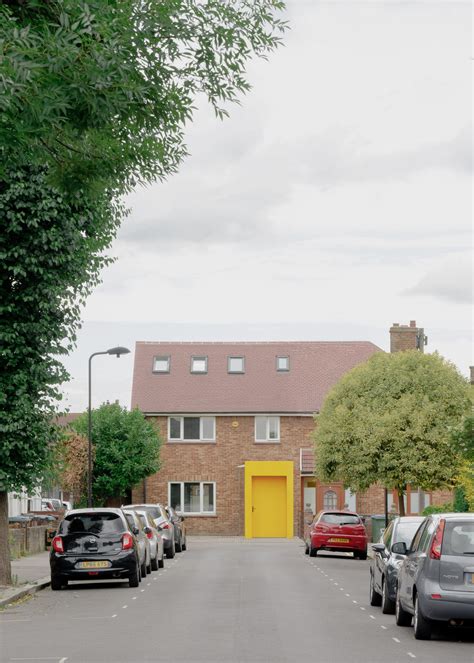 Unknown Works Finishes CLT House Extension With Bright Yellow Render