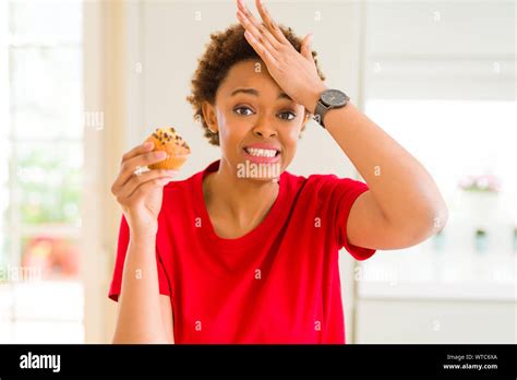 Young African American Woman Eating Chocolate Chips Muffins Stressed