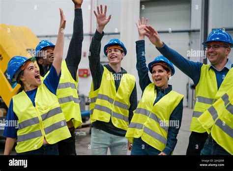 Group Of Workers In The Robotics Industry Celebrating The Successes Of