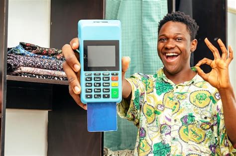 Premium Photo Young African Man Using A Handheld Pos System For Small Premium Photo Young African Man Using A Handheld Pos System For Small