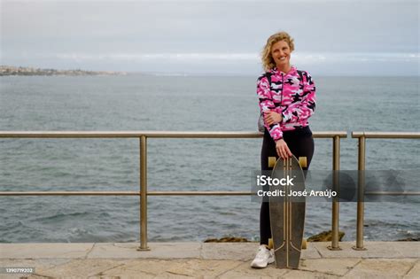 스케이트 보드를 손에 들고 바다 옆의 바다 벽에있는 여자 30 39세에 대한 스톡 사진 및 기타 이미지 30 39세 관광객 도시 Istock