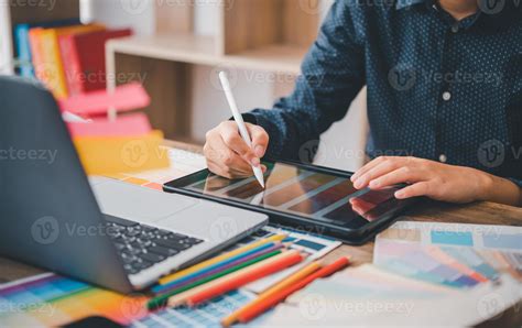 Graphic Designer Architects Who Work With Laptops And Color Comparison Tables For Design Work