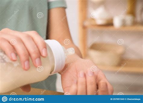 Woman Checking Temperature Of Infant Formula Indoors Closeup With