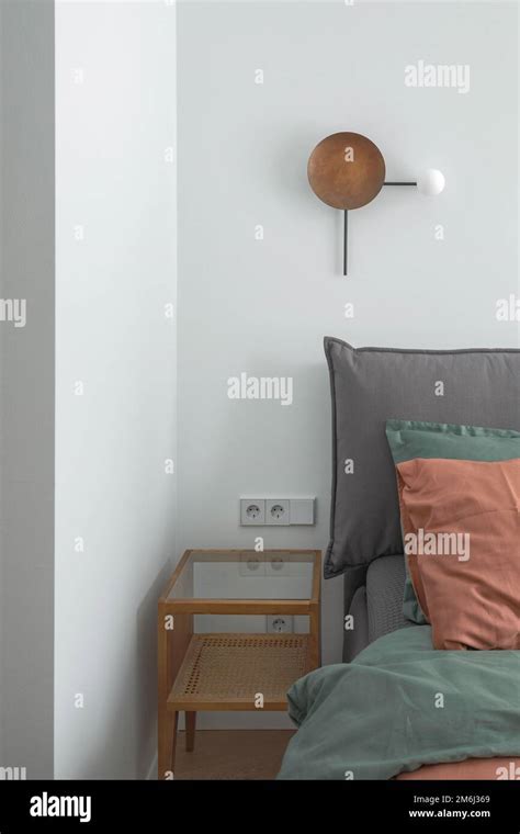 Bedroom Interior With Rust Color Linen And Cushions On A Bed Grey Blanket Rattan Bedside Table